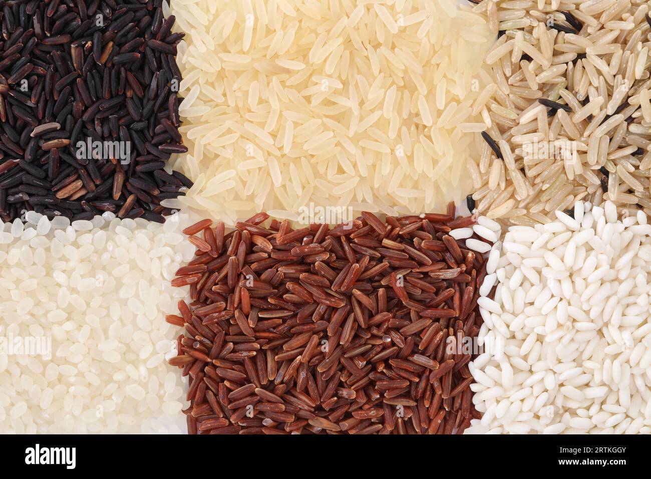 Different sorts of rice as background, top view Stock Photo - Alamy
