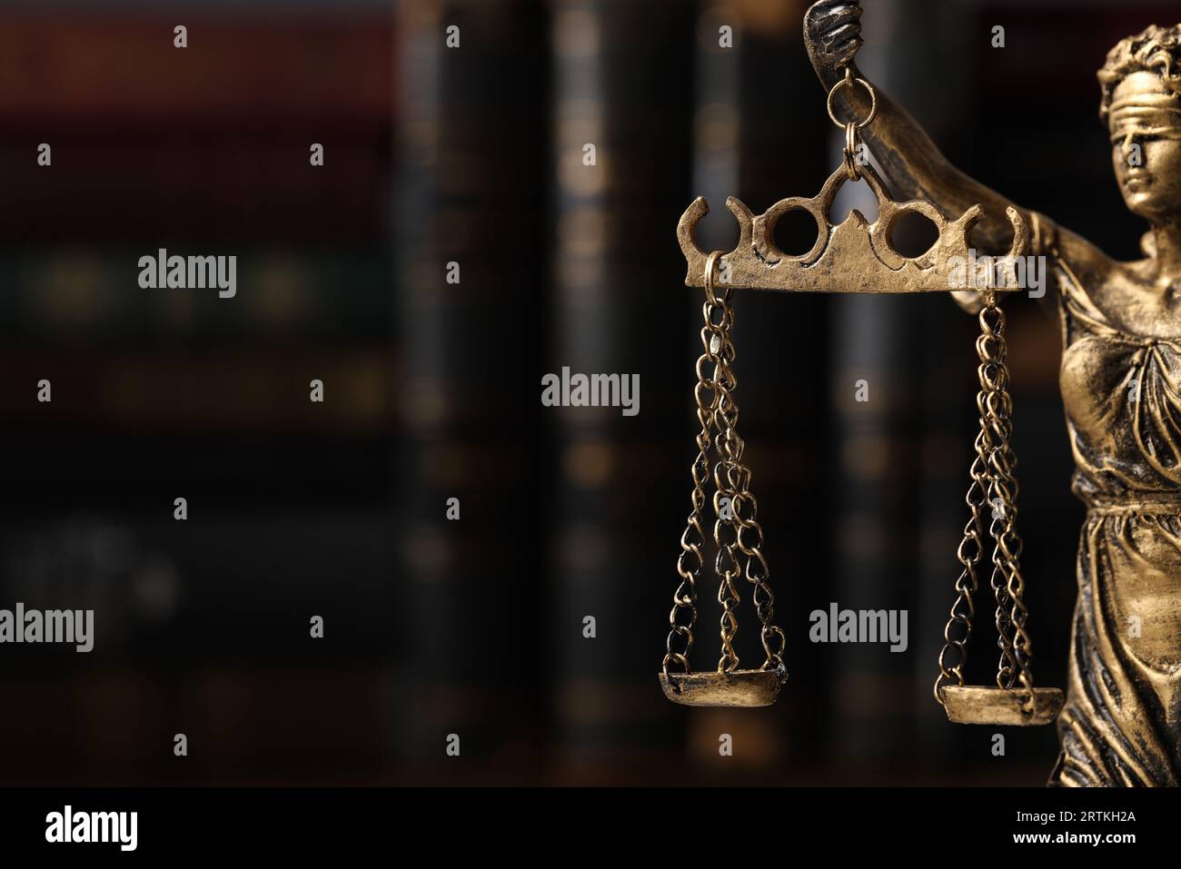 Symbol of fair treatment under law. Statue of Lady Justice near books ...