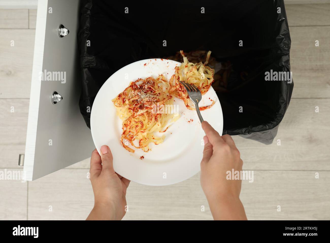 Woman throwing plate of food bin hi-res stock photography and images ...