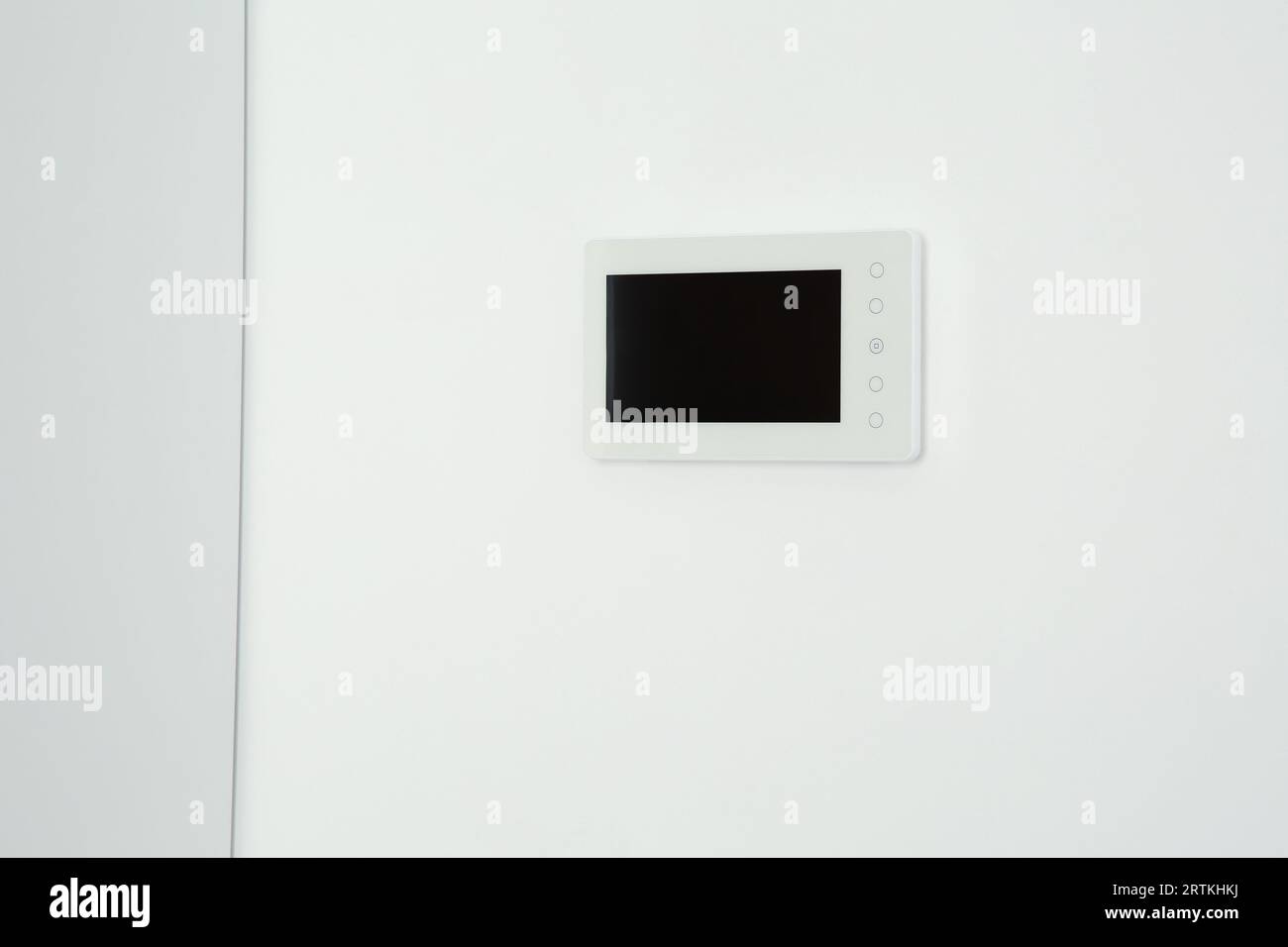 Modern video intercom hanging on white wall Stock Photo - Alamy