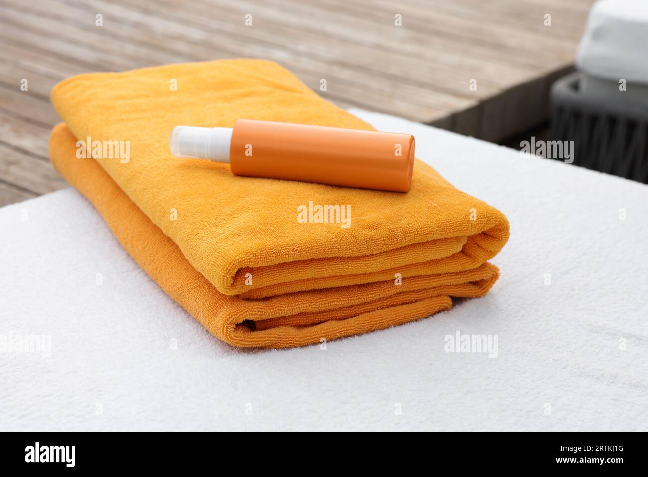 Beach towels and sunscreen on sunbed at resort Stock Photo - Alamy