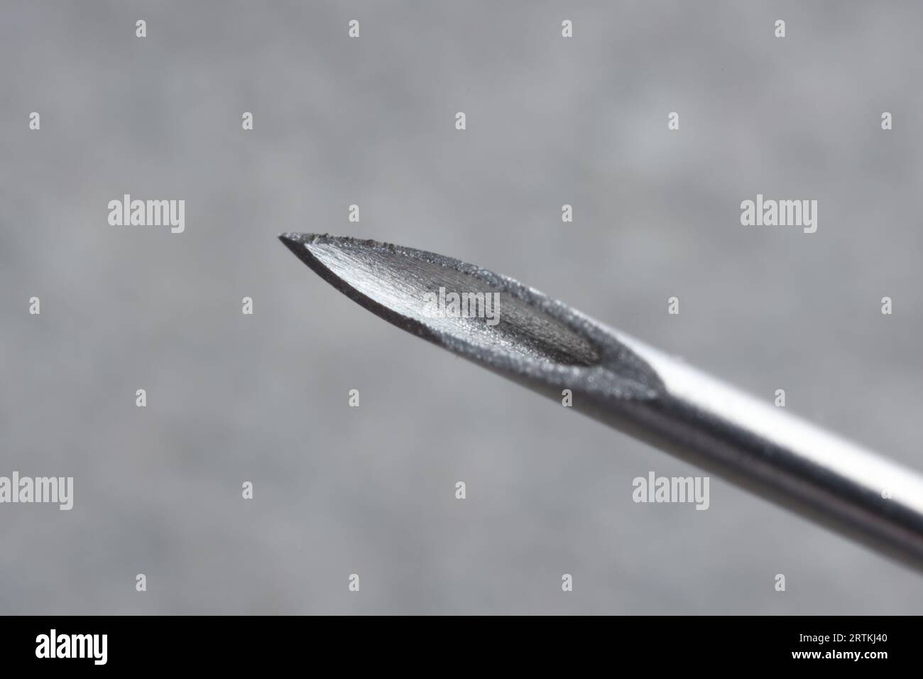 Macro photo of medical needle on blurred grey background Stock Photo ...