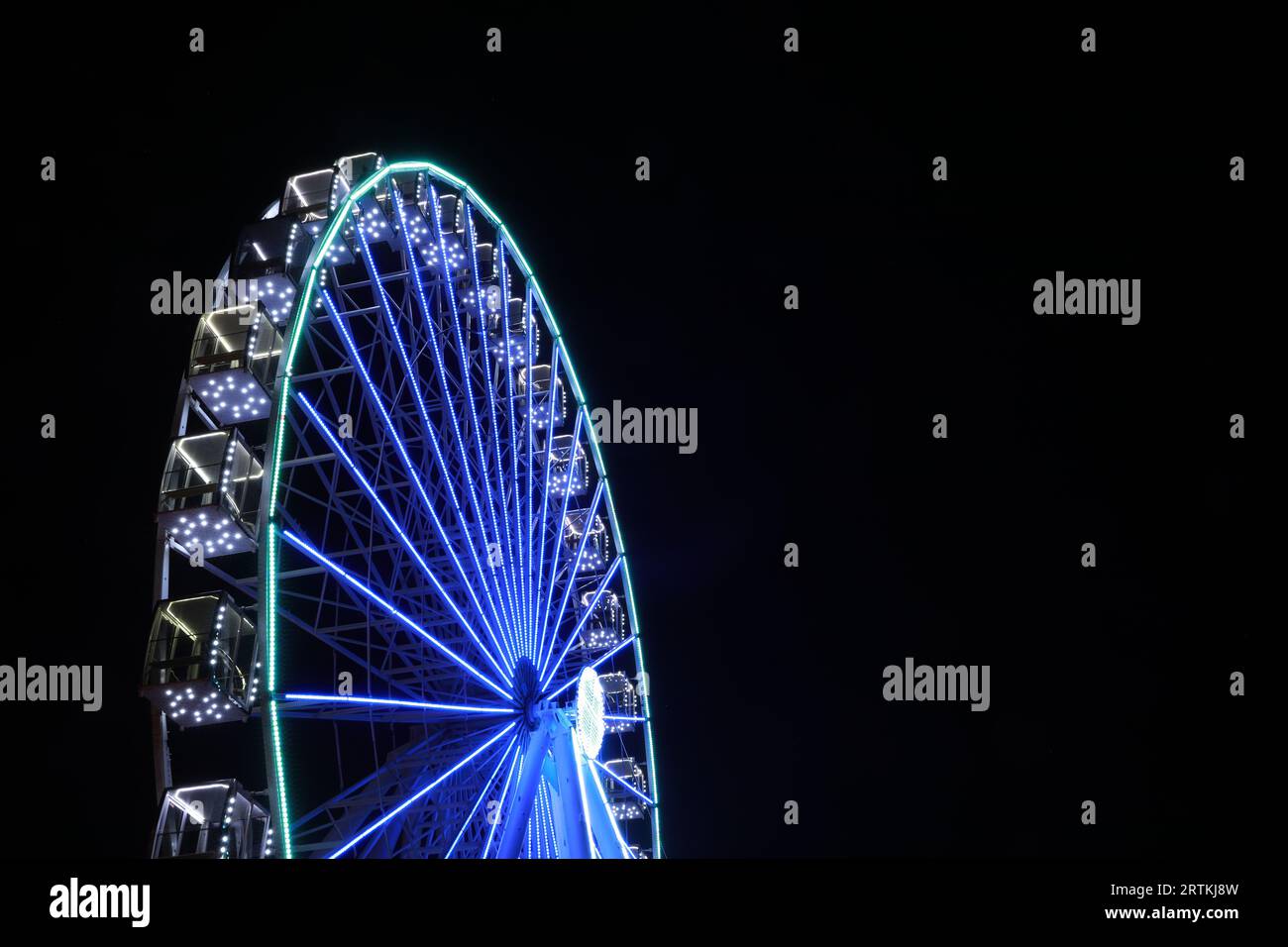 Beautiful glowing Ferris wheel against dark sky. Space for text Stock ...