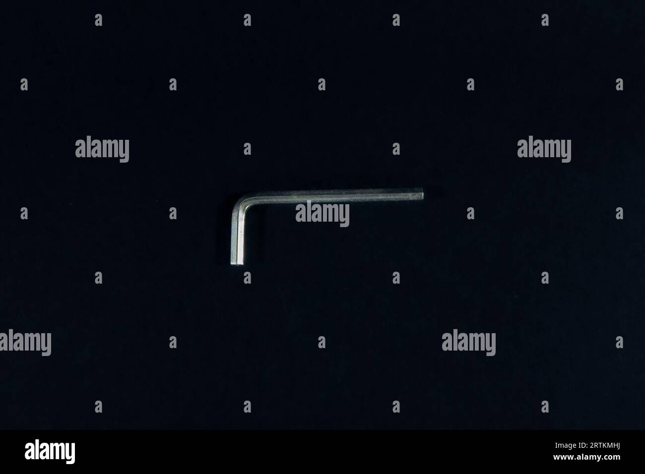 Picture of a hex key on a black background. A hex key (also, hex wrench ...