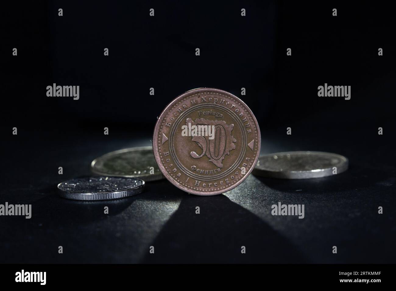 Picture of bosnian coin on a black background, with a focus on a coin ...