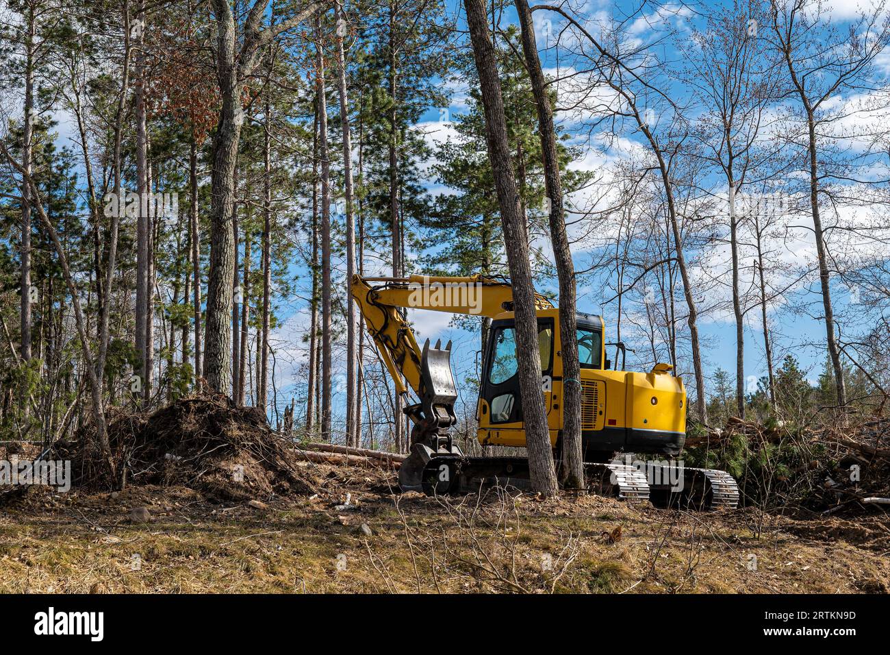 Yellow excavator machine or digger with bucket and tracks is used in ...