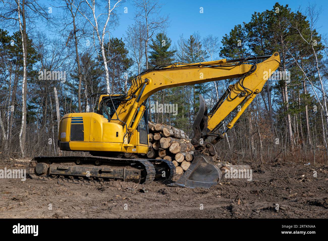Yellow excavator or digger machine parked on the dirt at a building ...