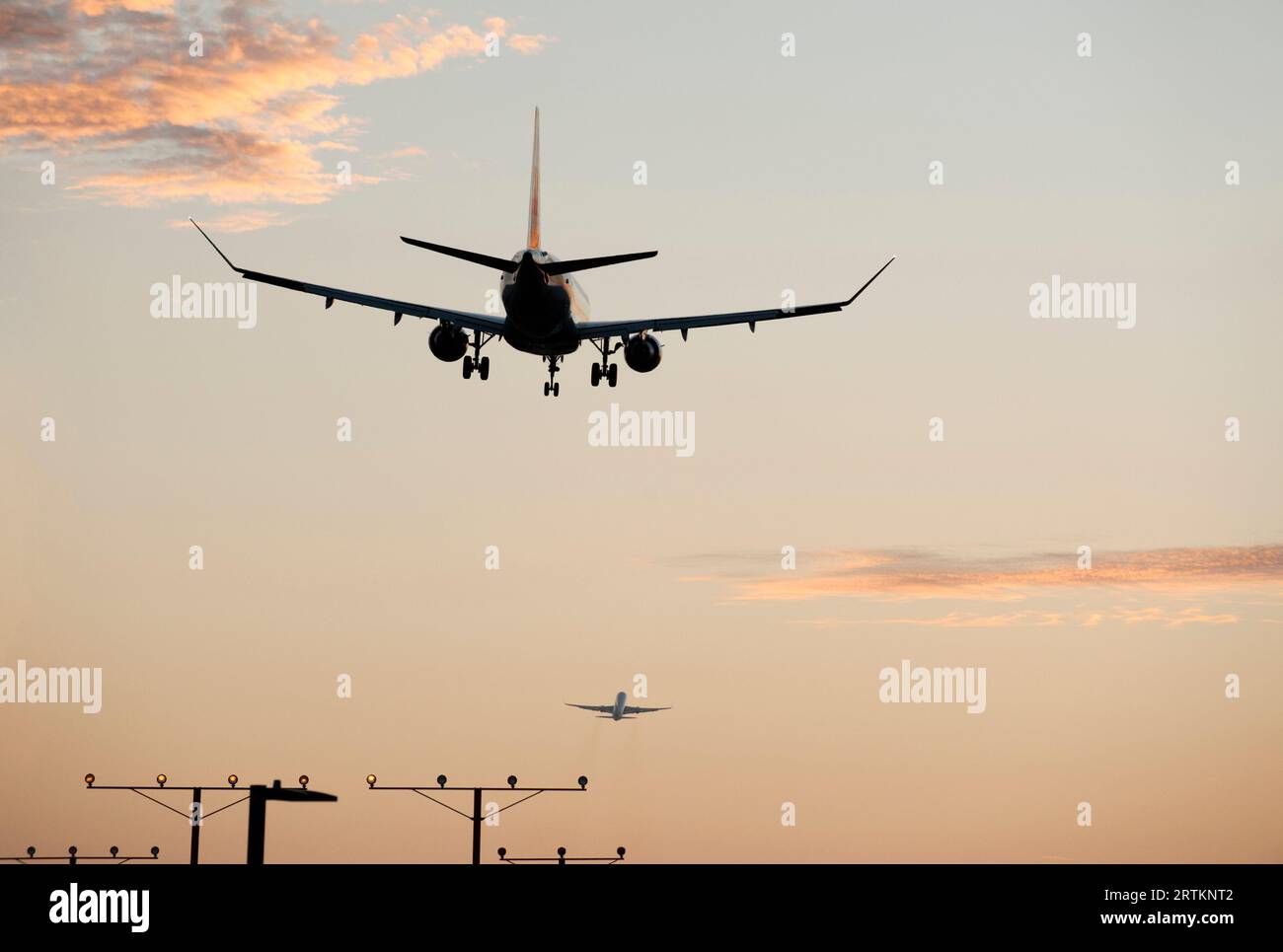Plane with landing gear down approaching LAX airport as another plane ...