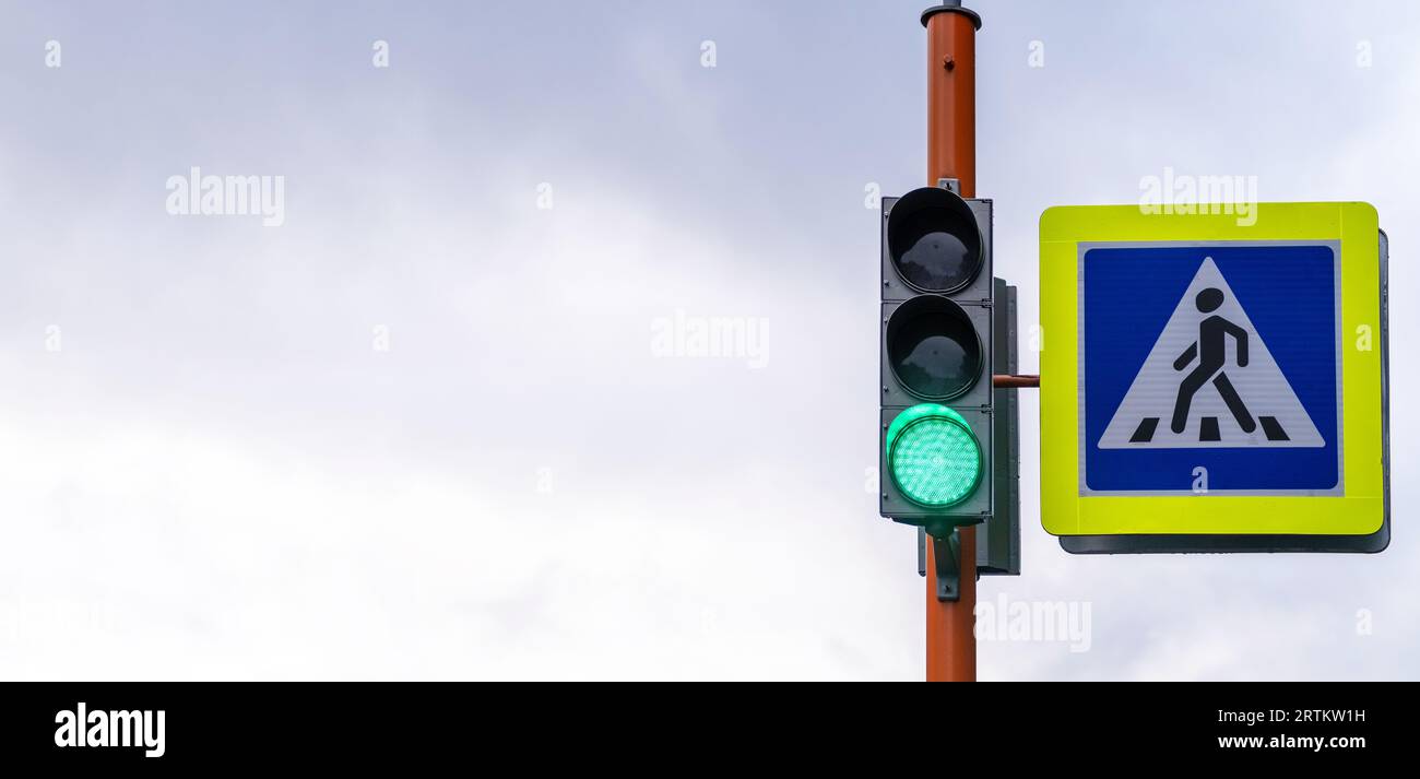 A pedestrian crossing sign with a reflective coating and a traffic ...
