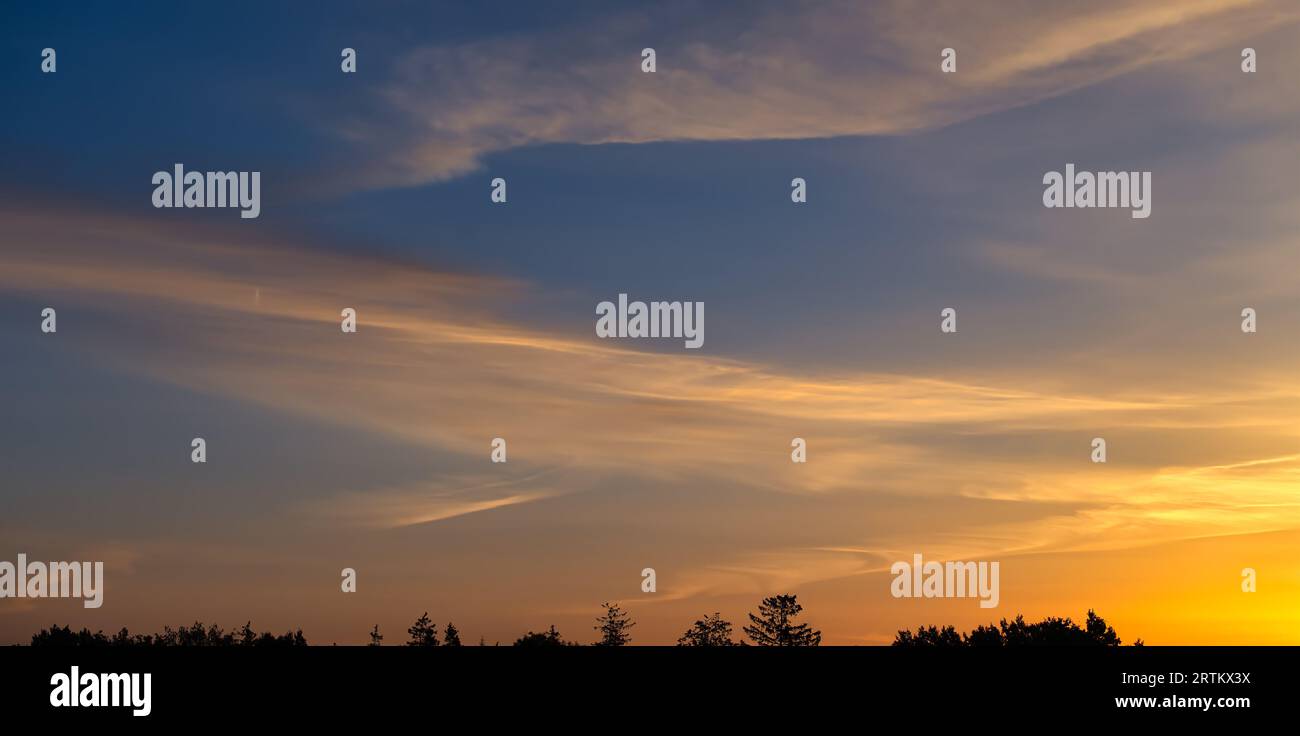 Sky is beautifully filled with clouds, their shapes accentuated by the ...
