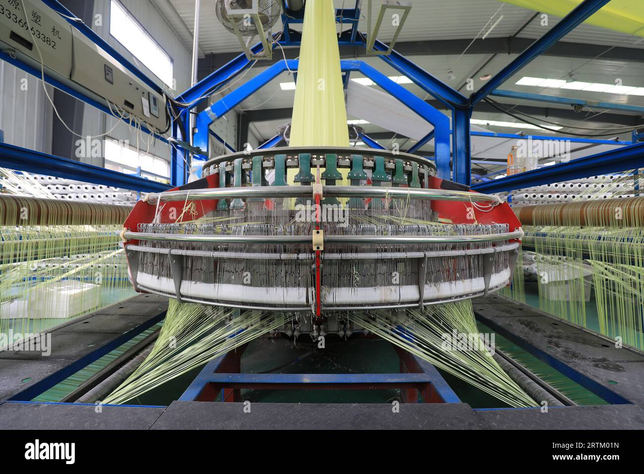 Mechanical equipment of plastic weaving factory Stock Photo - Alamy