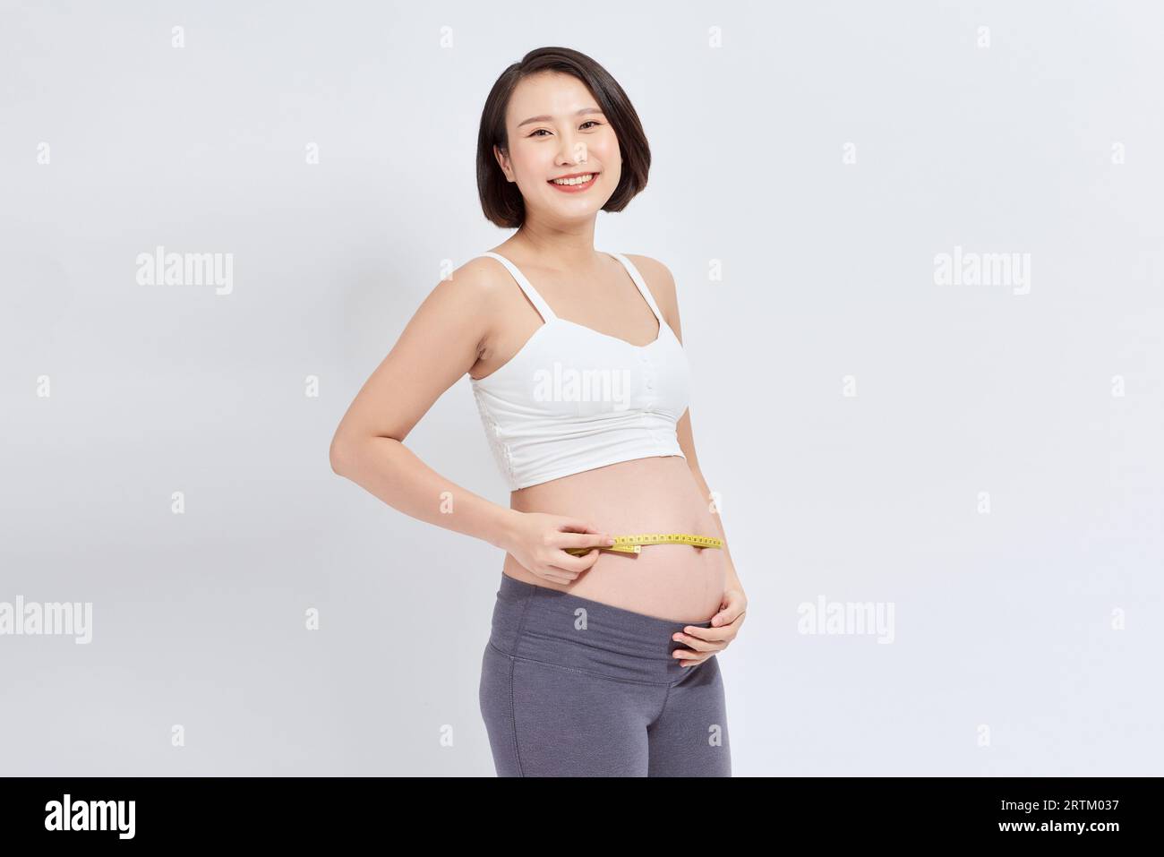 Portrait Happy Young Pregnant Woman Measuring Stomach With Tape Measure