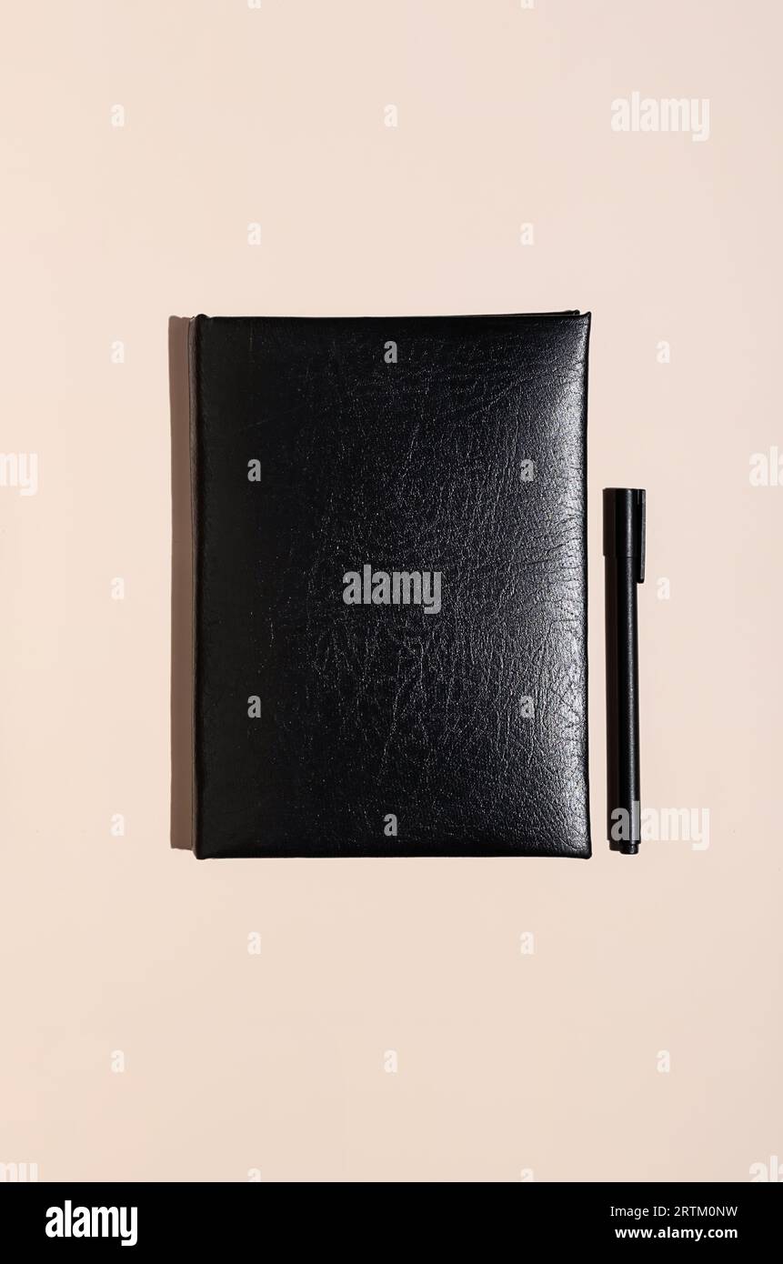 Black leather cover notebook layout Stock Photo - Alamy