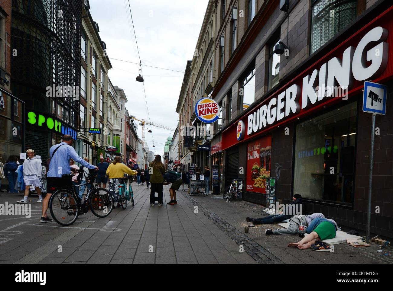 Homeless people laying on the street outside Burge King on ...