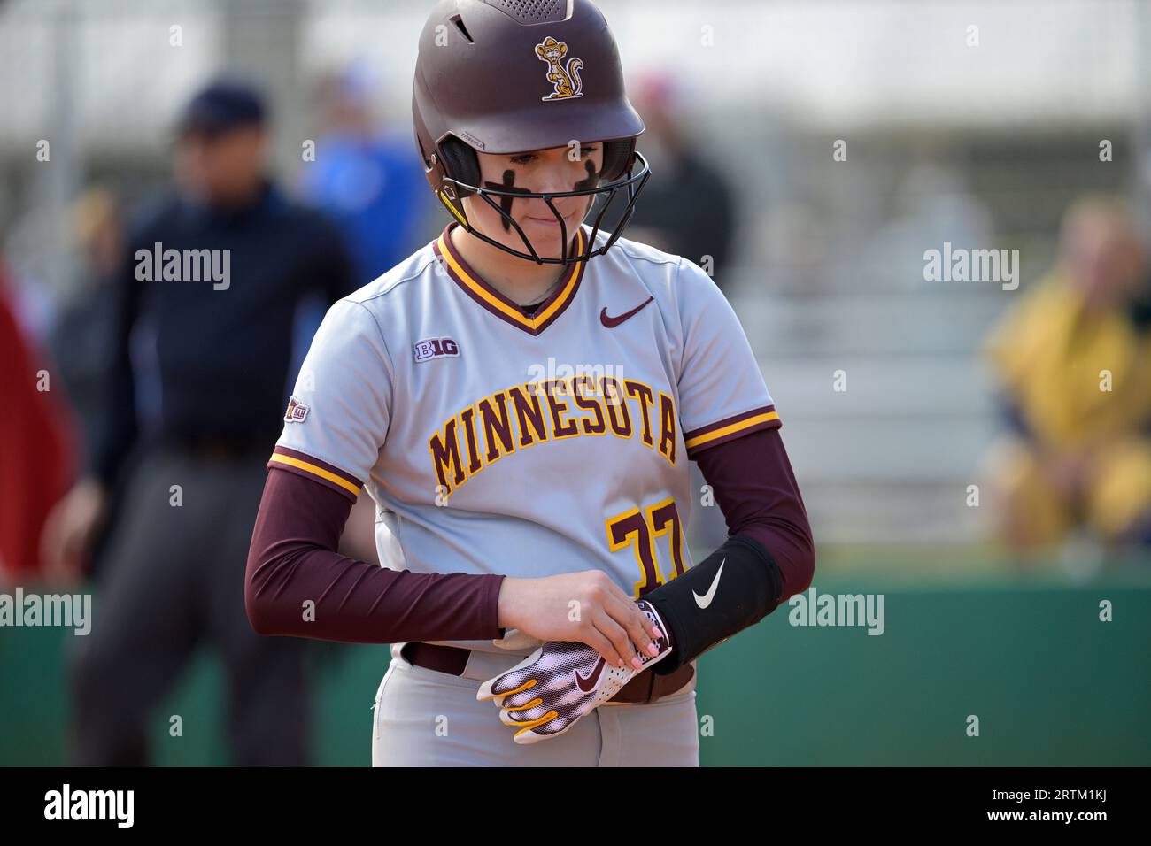 Minnesota's Kayla Chavez (77) walks back to the dugout after being ...