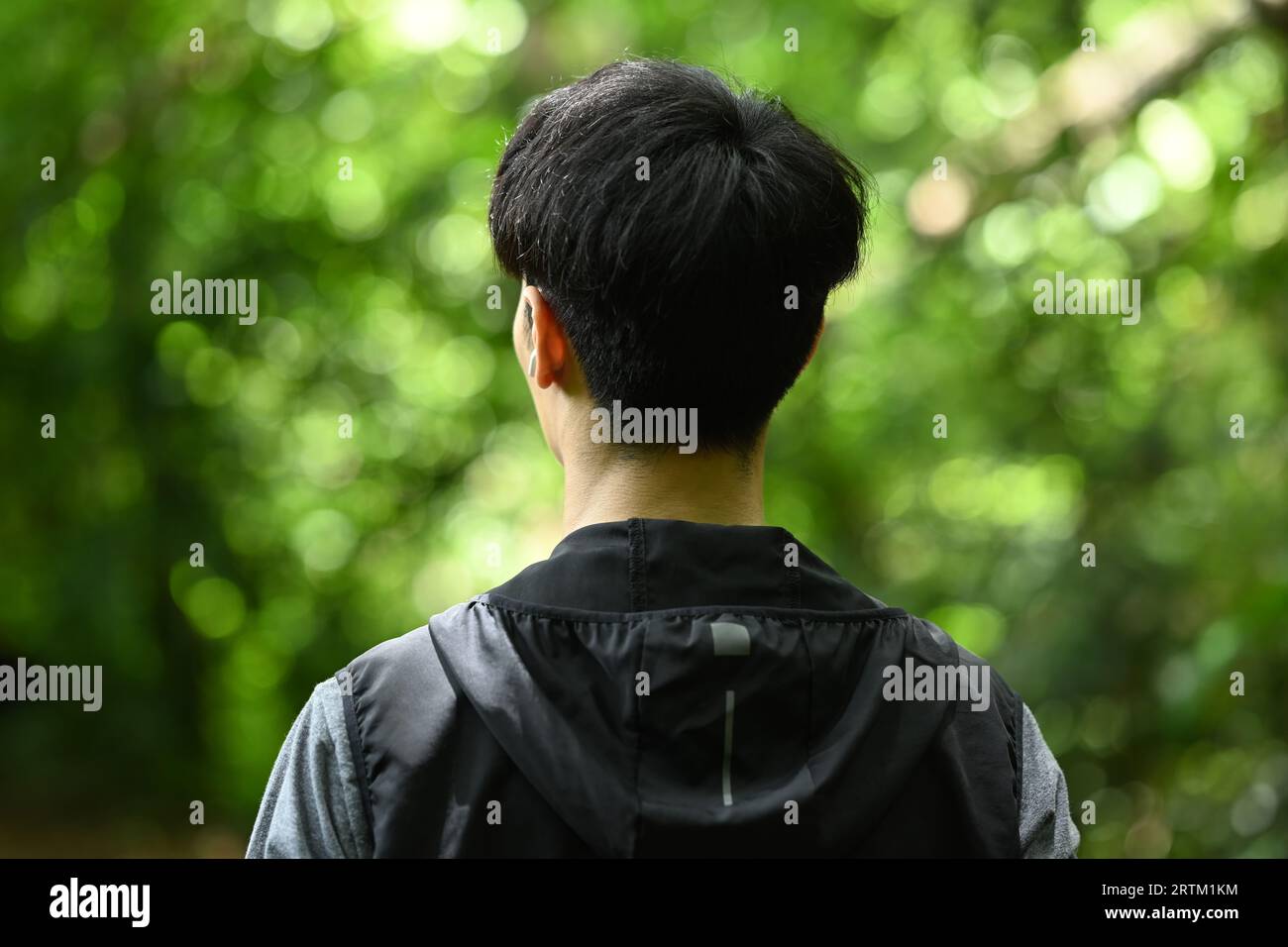 Rear view of male athlete running on a forest path. Sports motivation ...