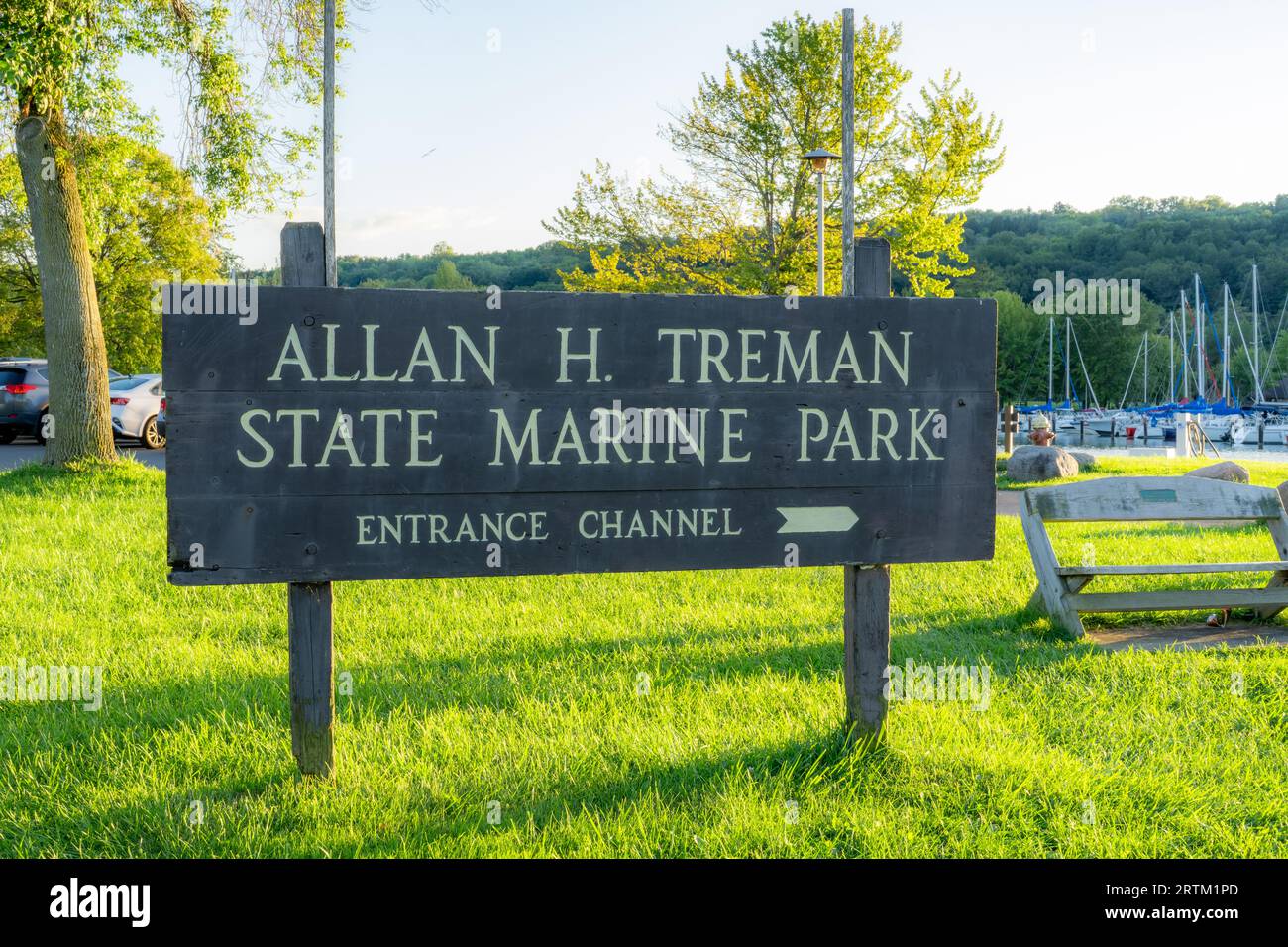 Weathered brown and gold wood sign on post, Allan H Treman State Marine ...