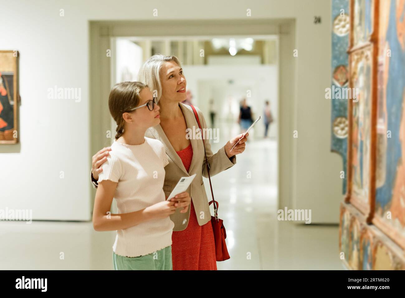 Woman and girl visiting museum Stock Photo - Alamy