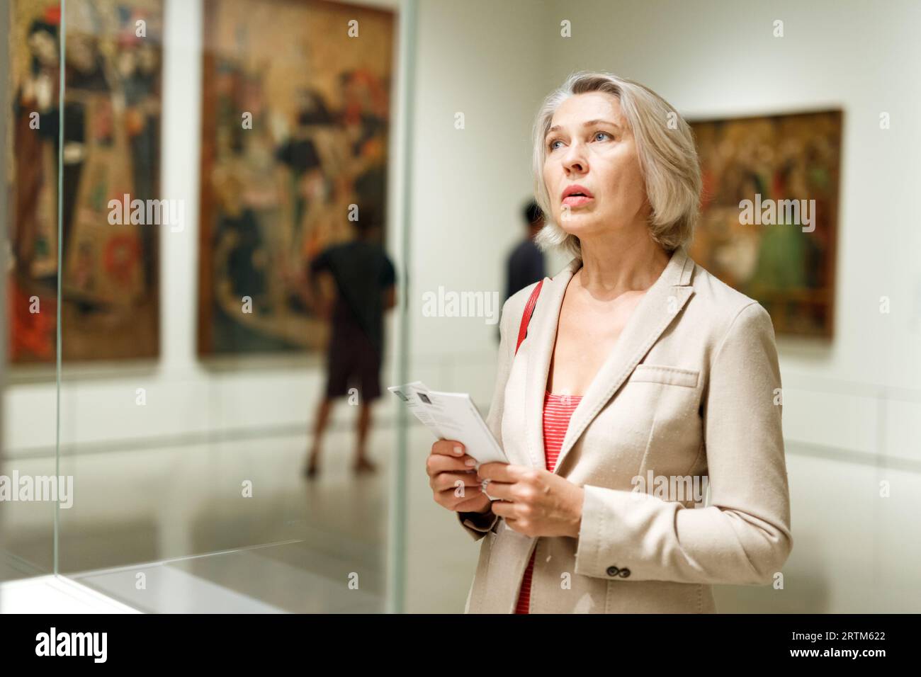 Mature woman visiting museum Stock Photo - Alamy