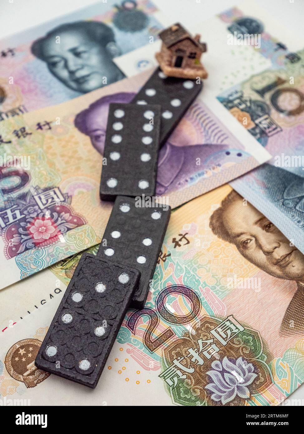 domino effect and house on chinese yuan currency background concept ...