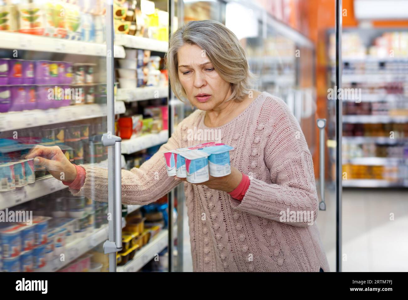 Shocked elderly woman reading product label Stock Photo - Alamy