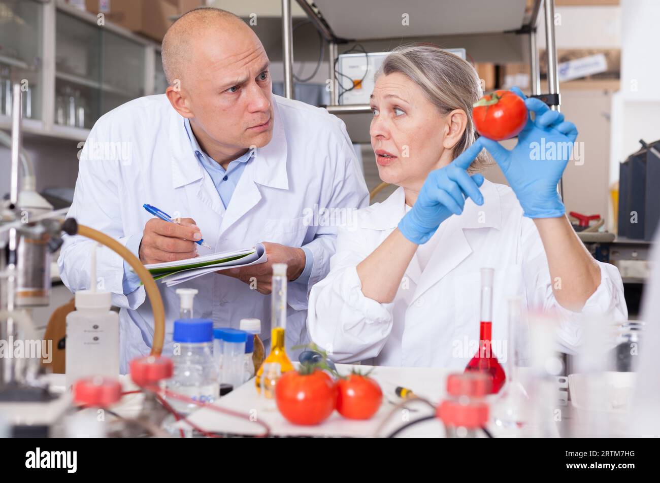 Scientists taking notes while performing experiments Stock Photo - Alamy