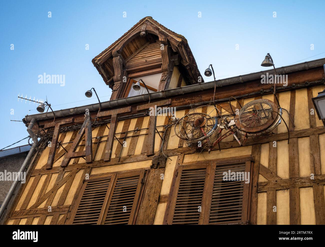 A large elaborate sign made from metal and old bicycles reading "Tattoo ...