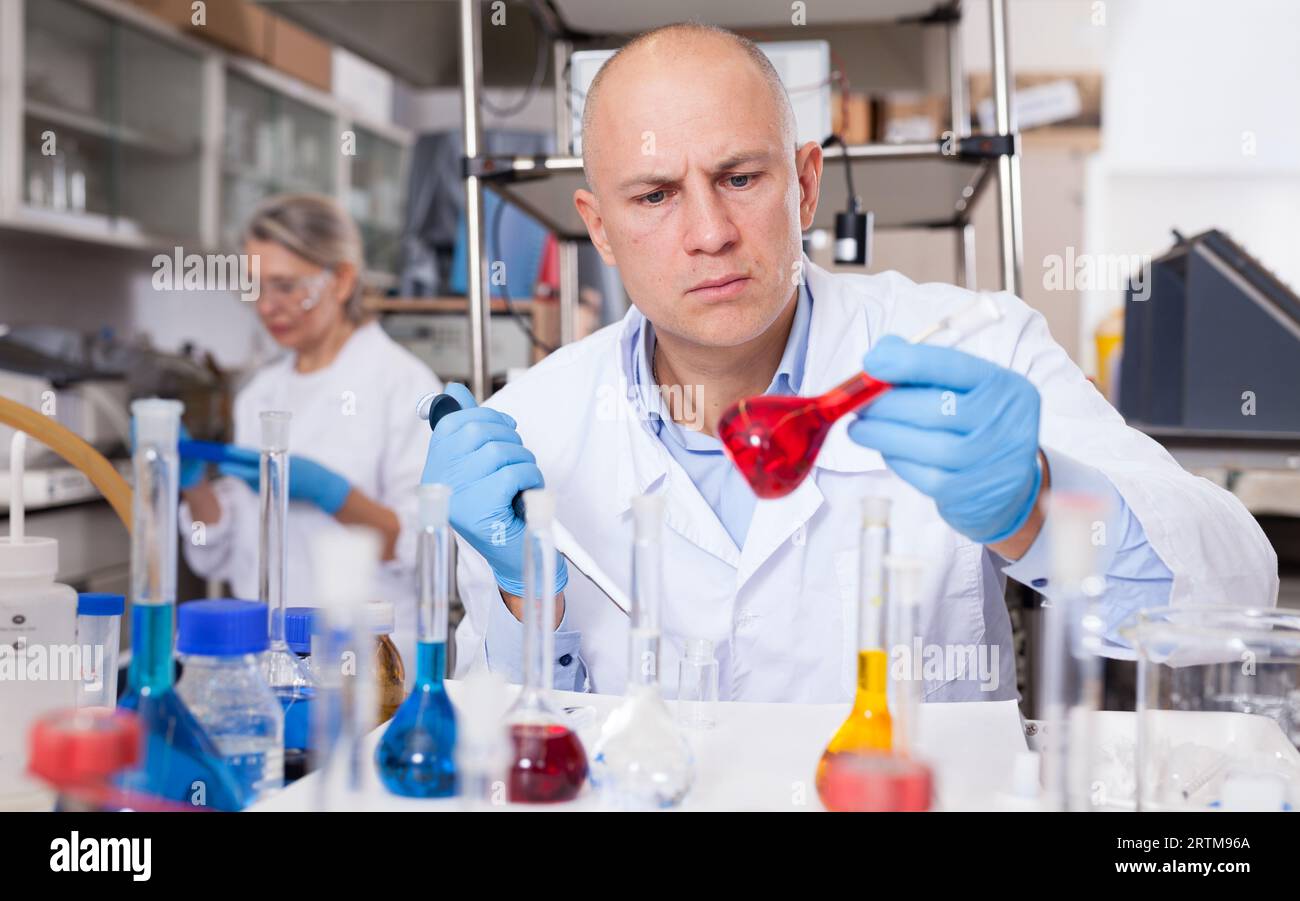 Biochemist analyzing chemical agents Stock Photo - Alamy