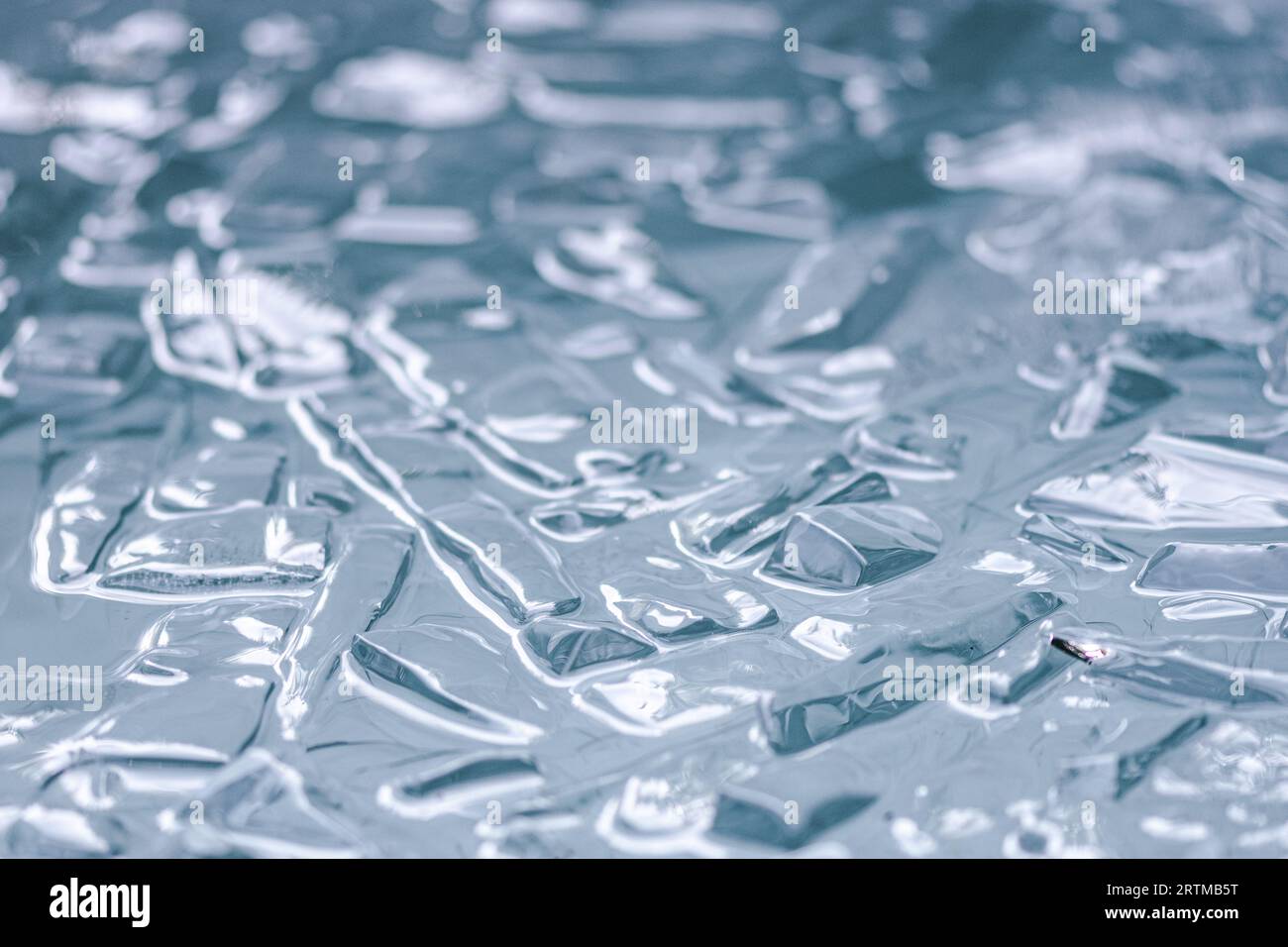 Cold water and ice cubes melting background. Global warming or climate ...