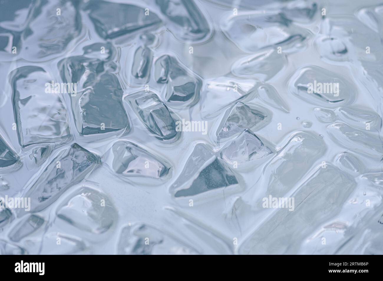 Cold water and ice cubes melting background. Global warming or climate ...