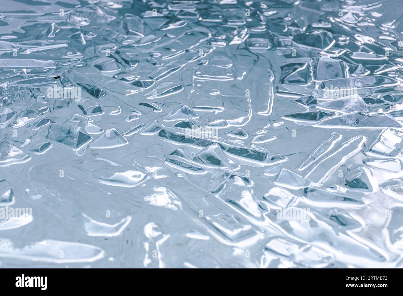 Cold water and ice cubes melting background. Global warming or climate ...