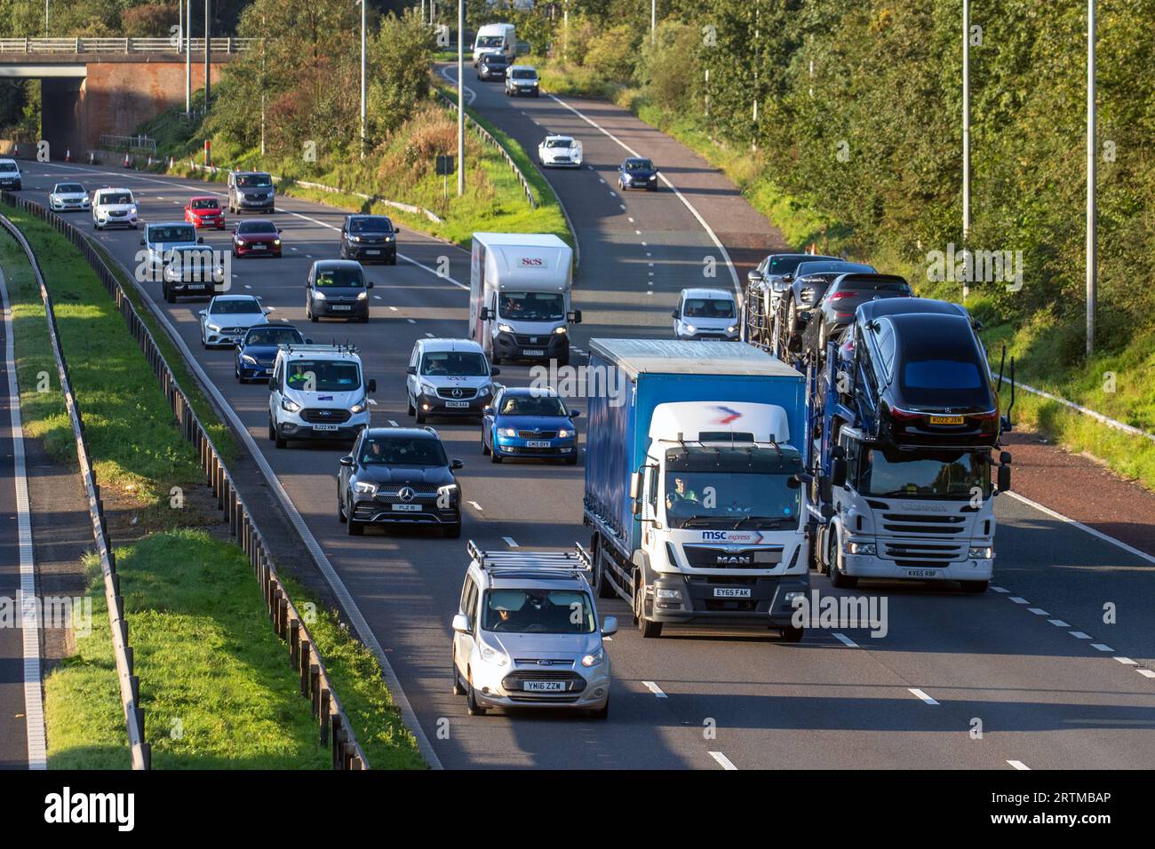 Busy M6 motorway junction with early morning commercial traffic in ...