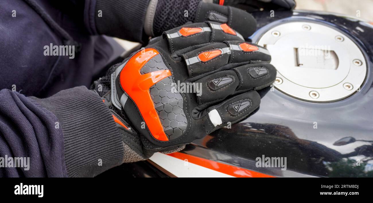 woman motorcyclist in a motorcycle gloves on a motorcycle close-up ...