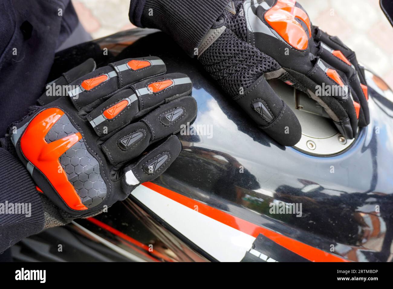 woman motorcyclist in a motorcycle gloves on a motorcycle close-up ...