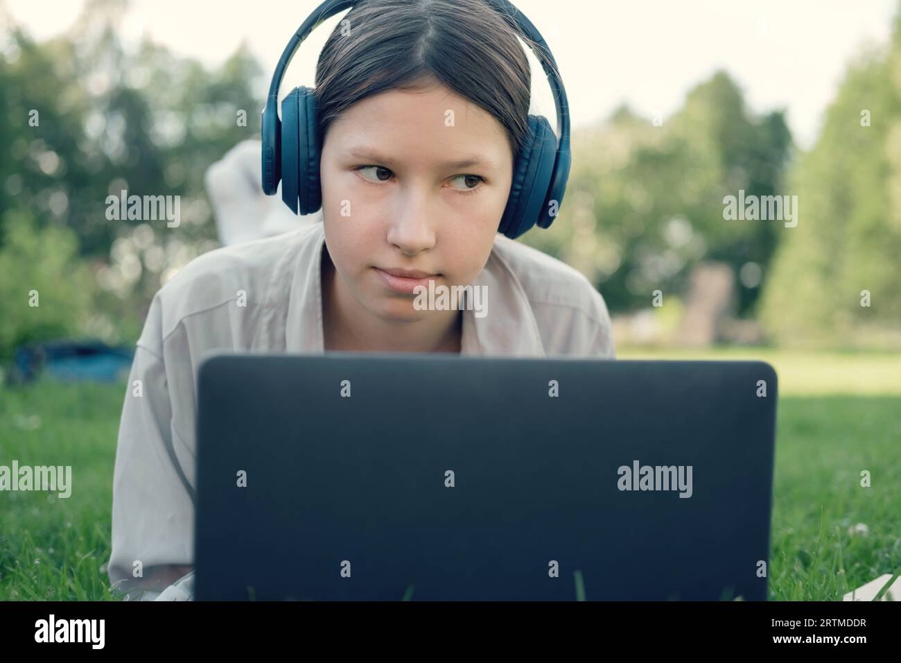 Teenage schoolgirl studying reading her books, tablet and notebook ...