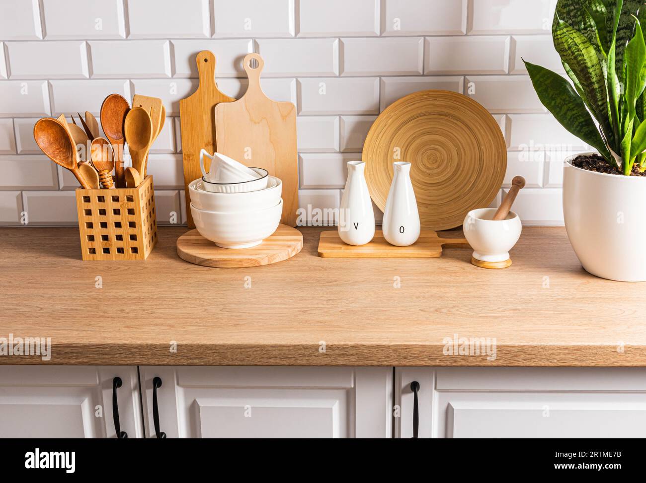 Many different items of kitchen wooden utensils on a wooden countertop ...