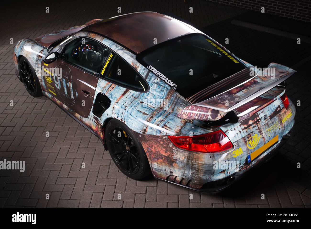 Night shoot with a Porsche 911 GT2 with a custom rusty 'rat car' wrap Stock Photo - Alamy