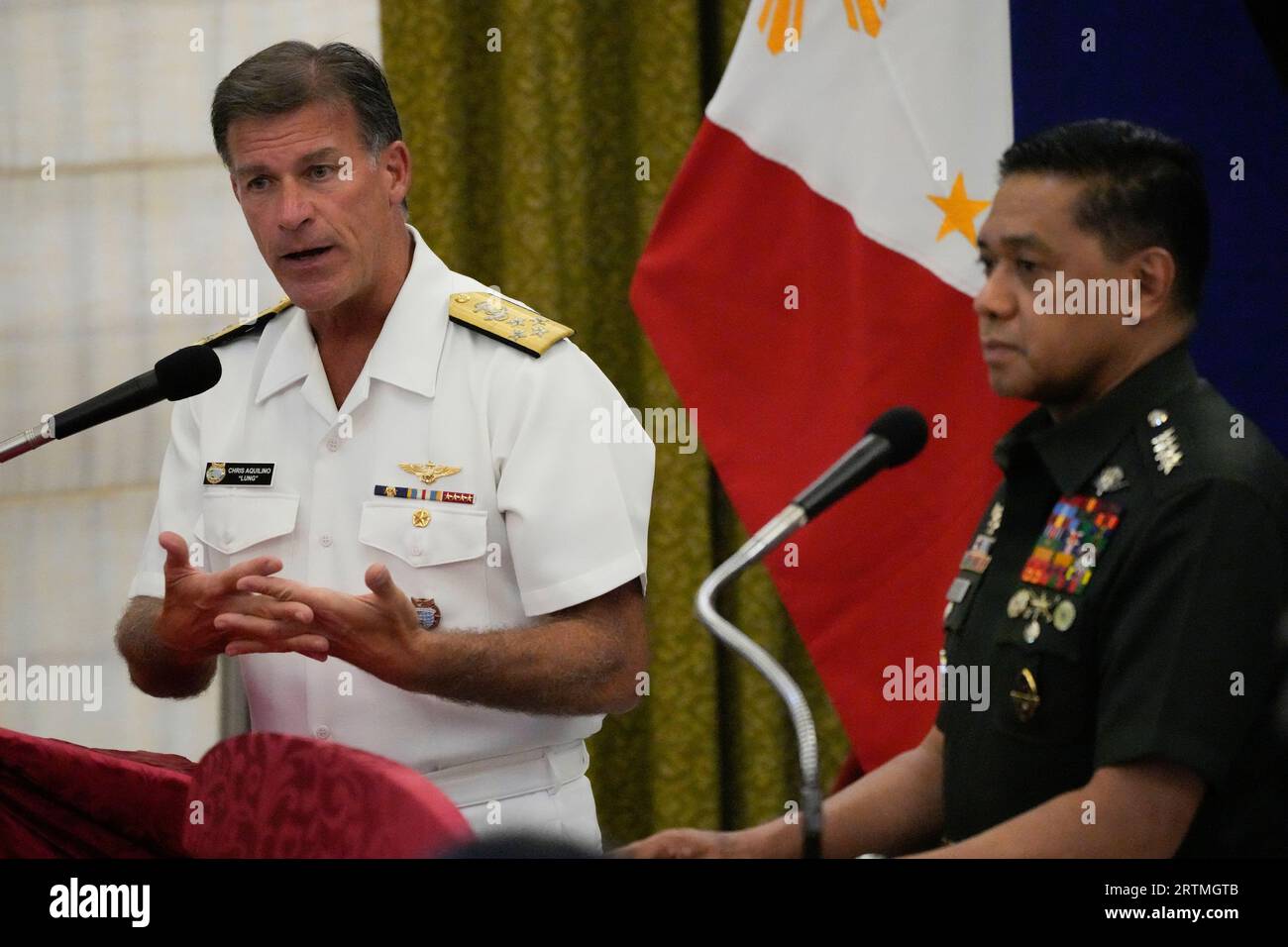 U.S. Indo-Pacific Command Chief Adm. John Aquilino, left, gestures beside Philippine Military ...
