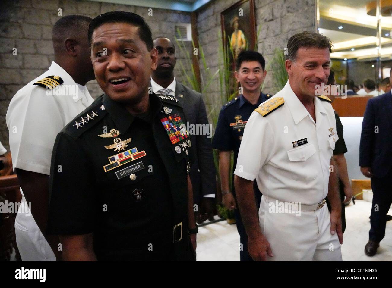 Philippine Military Chief Gen. Romeo Brawner Jr., left, walks beside U ...