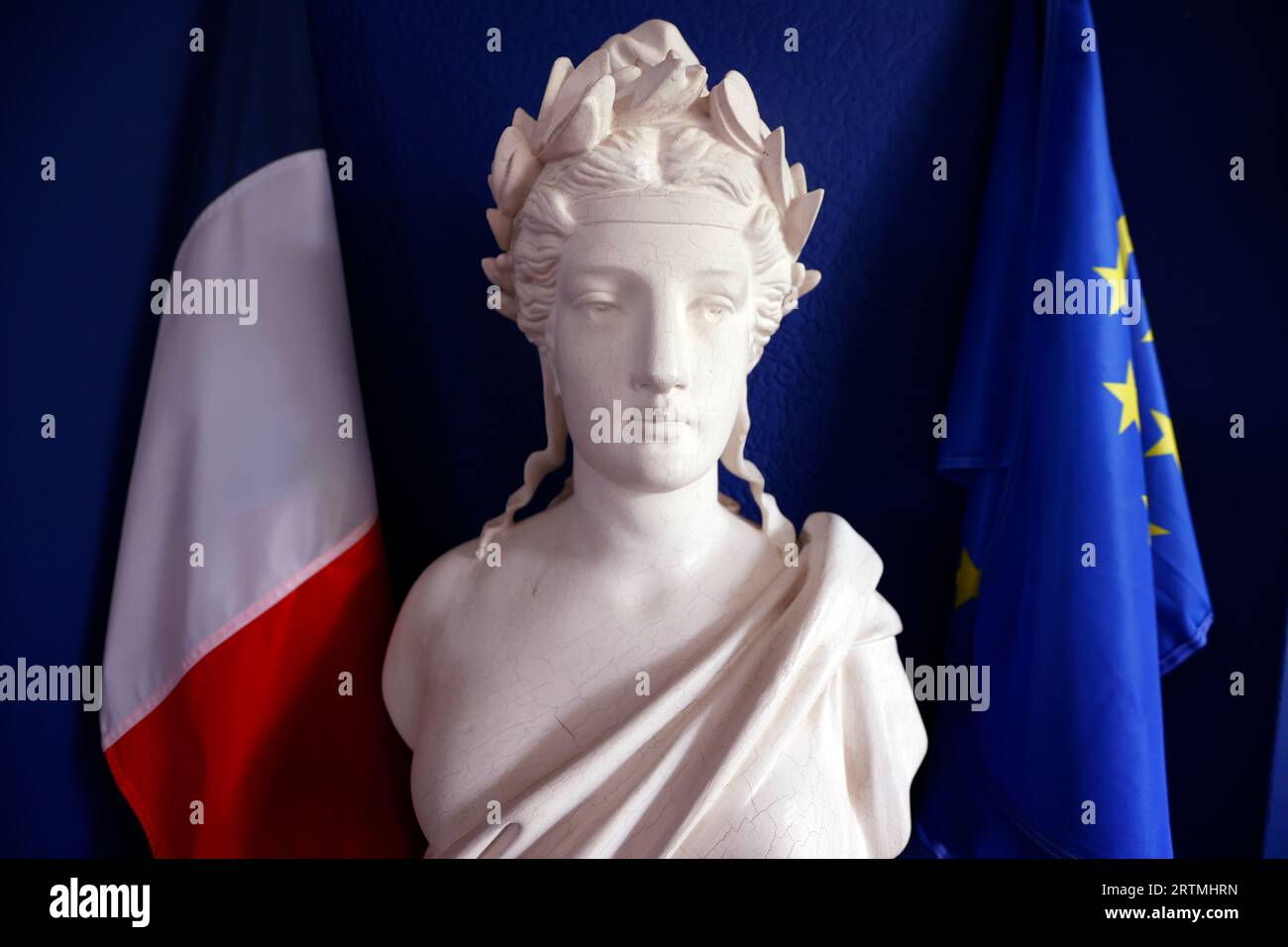 Statue of Marianne with french flag in city hall. Marianne is the ...