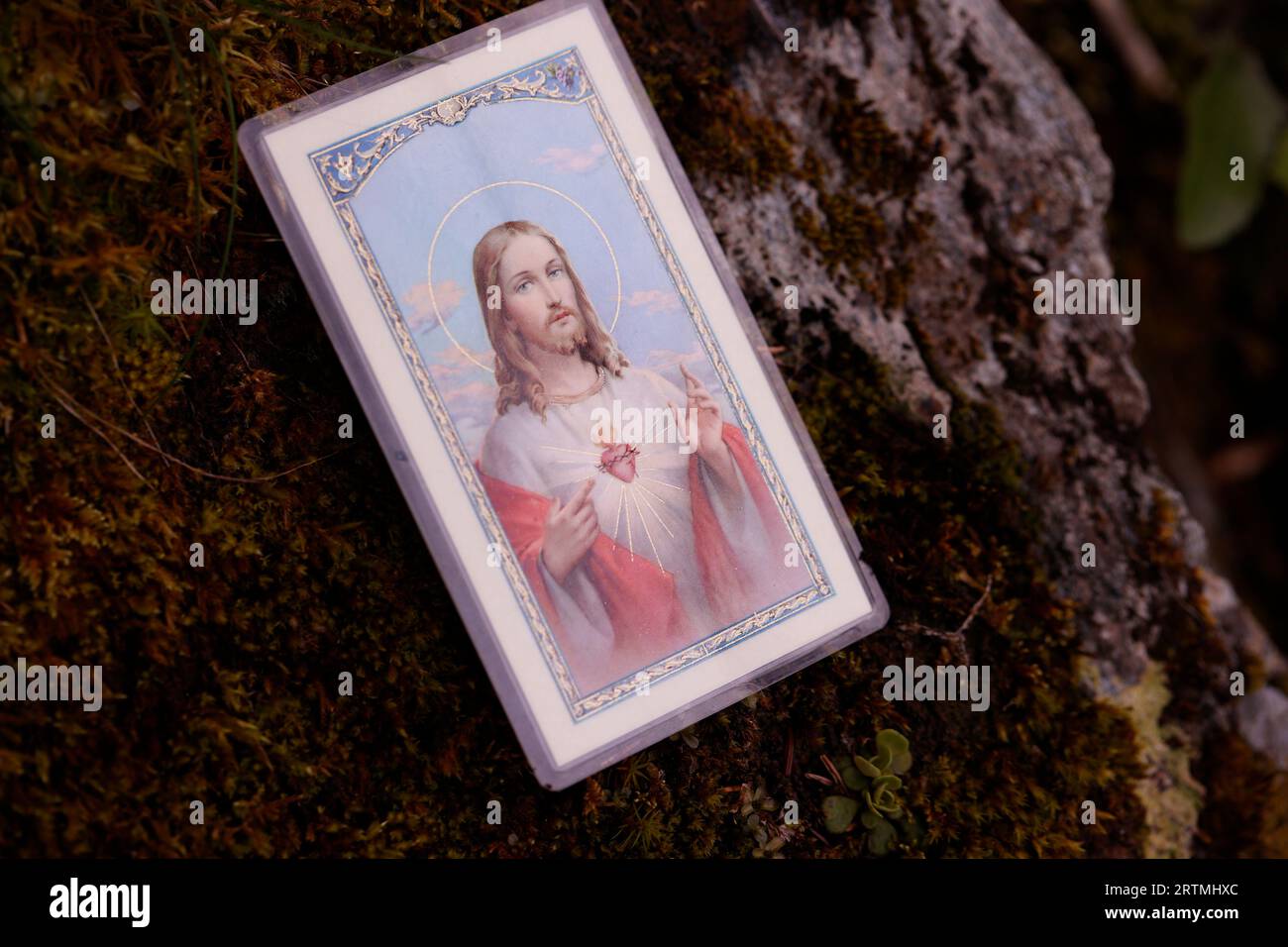 Jesus Christ image on a rock. His wounded hand points to the symbolic ...