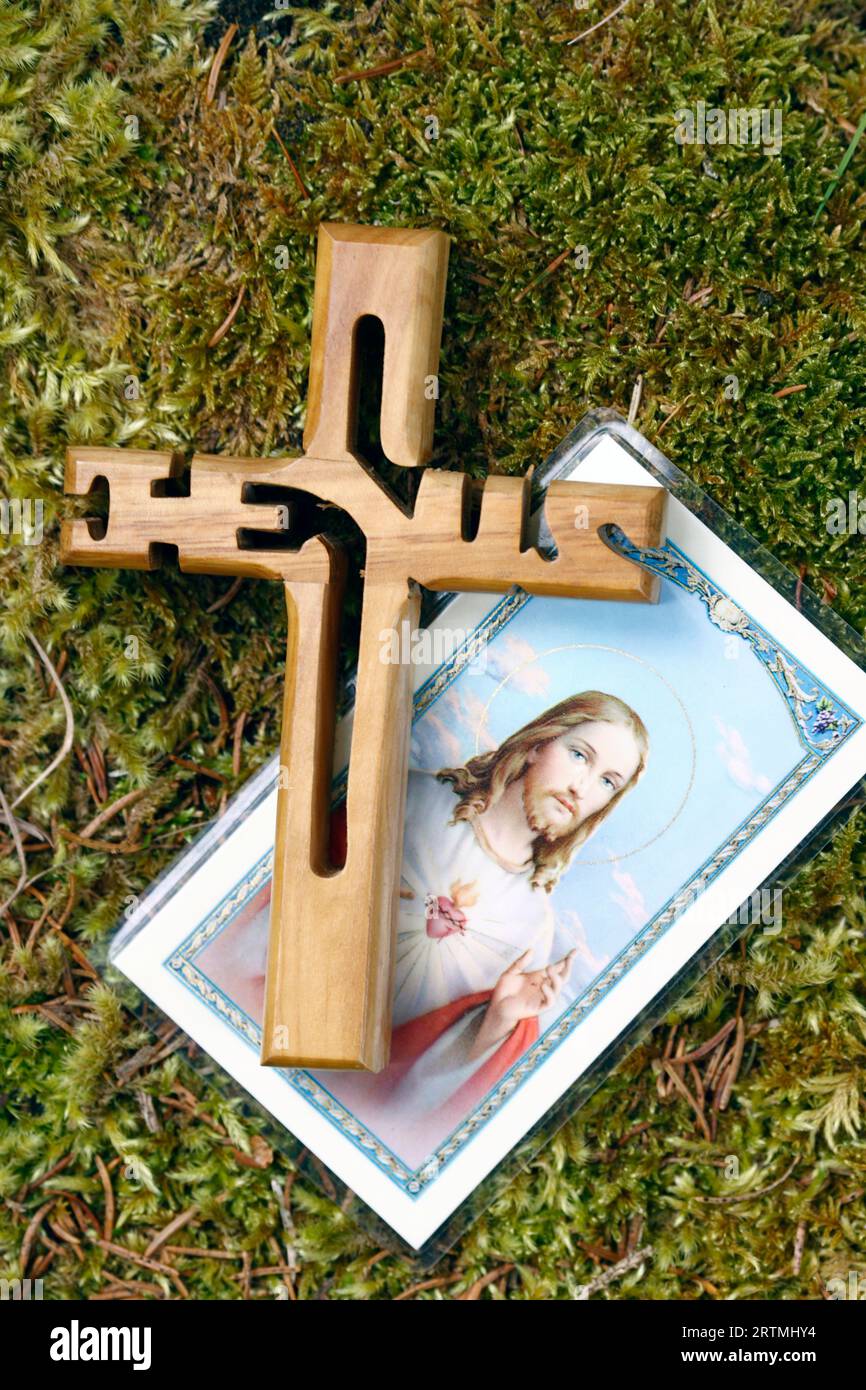 Catholic cross and Holy image of Jesus on green moss Stock Photo - Alamy