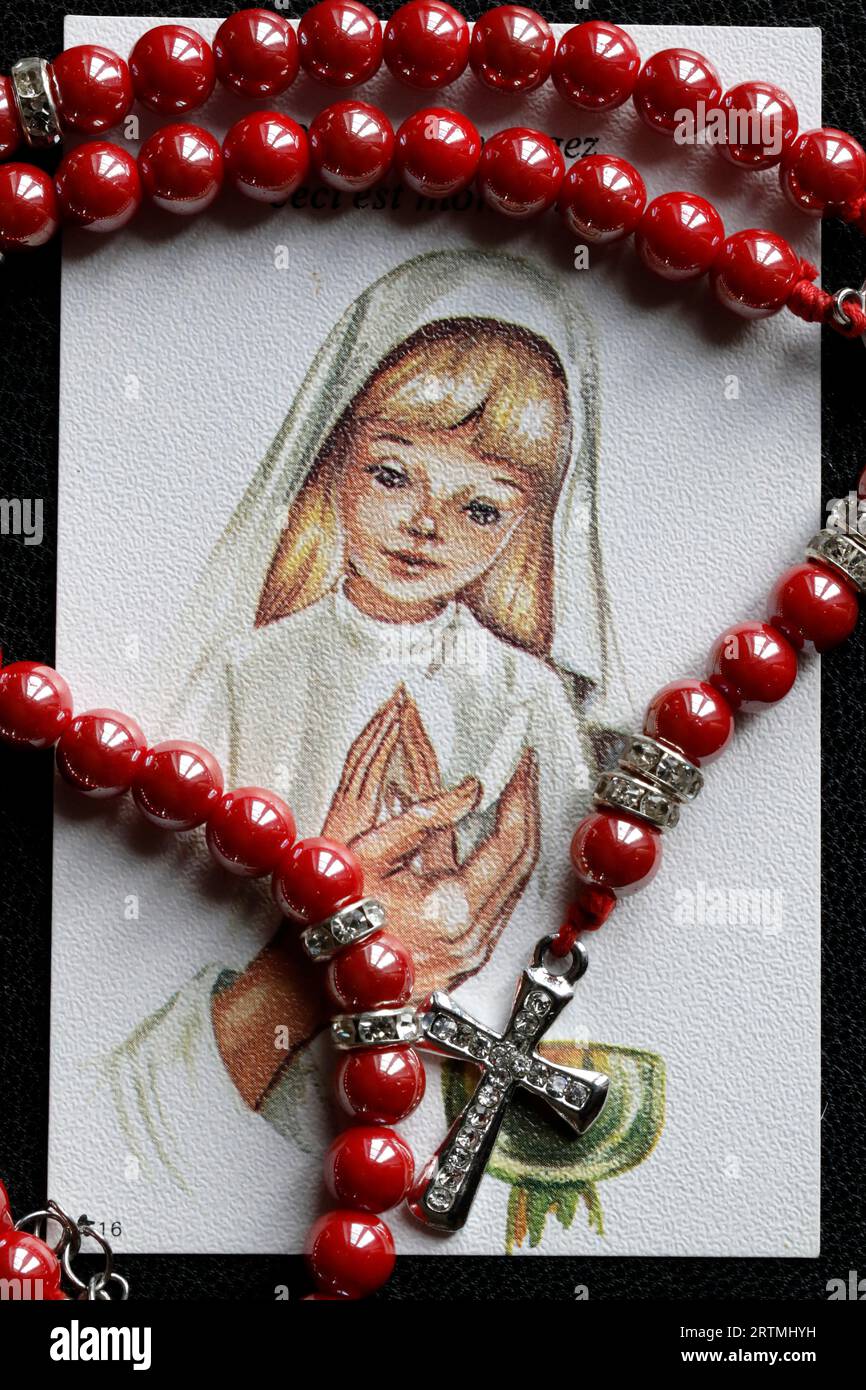 Holy image with rosary beads. First Communion Stock Photo - Alamy