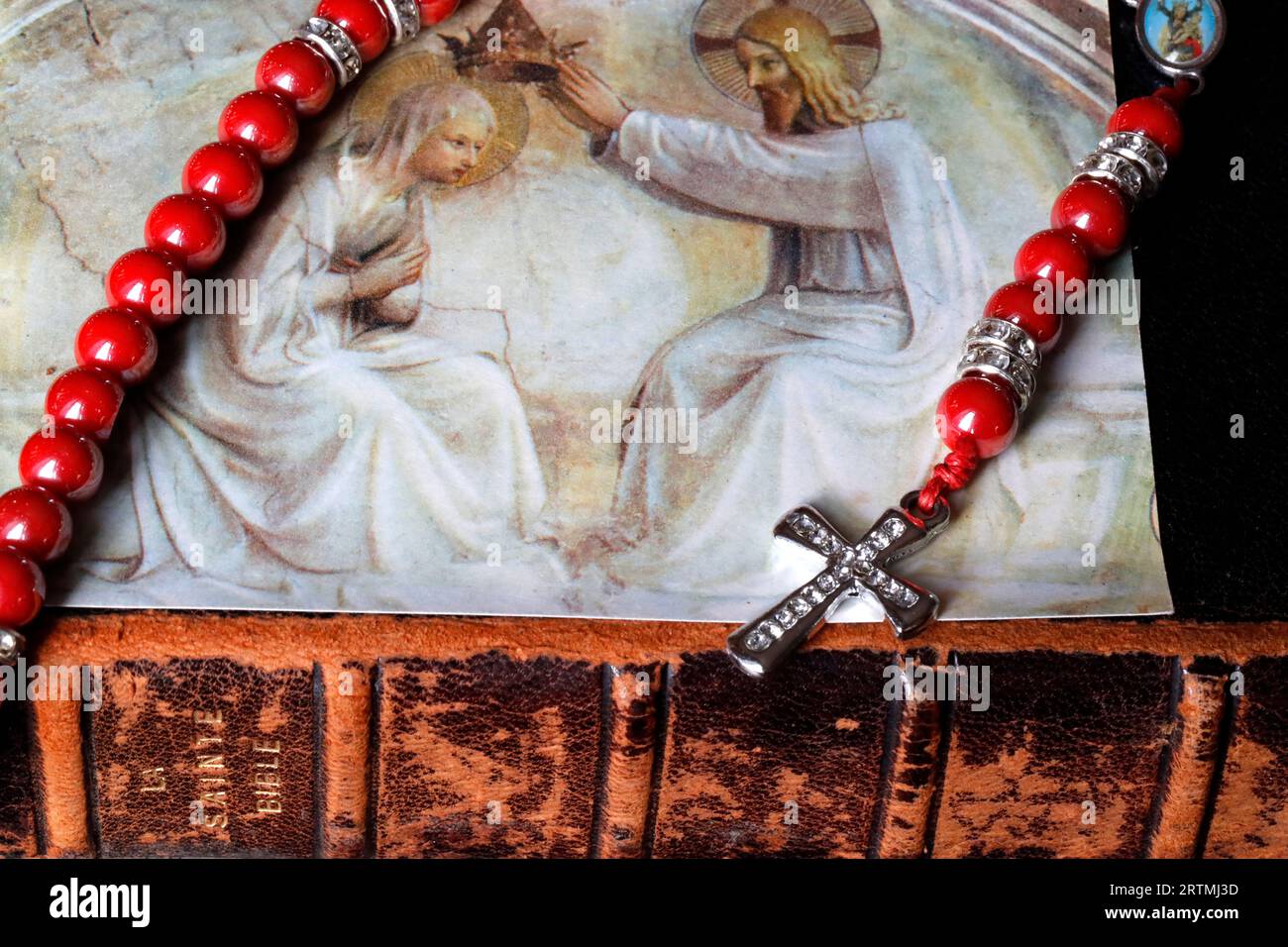 Holy image with rosary beads on a bible Stock Photo - Alamy