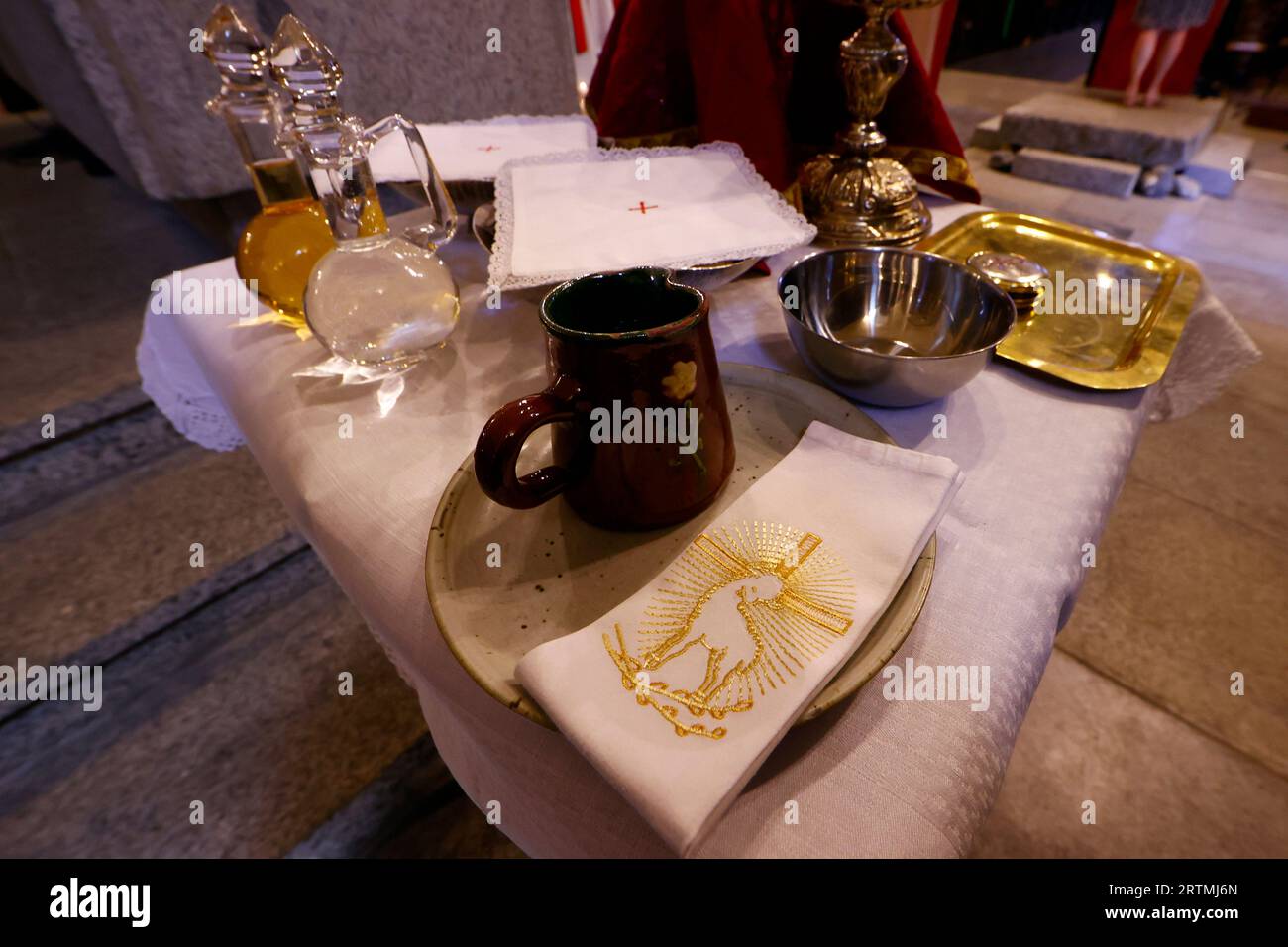 Catholic liturgical objects displayed over table at church. Chalice ...