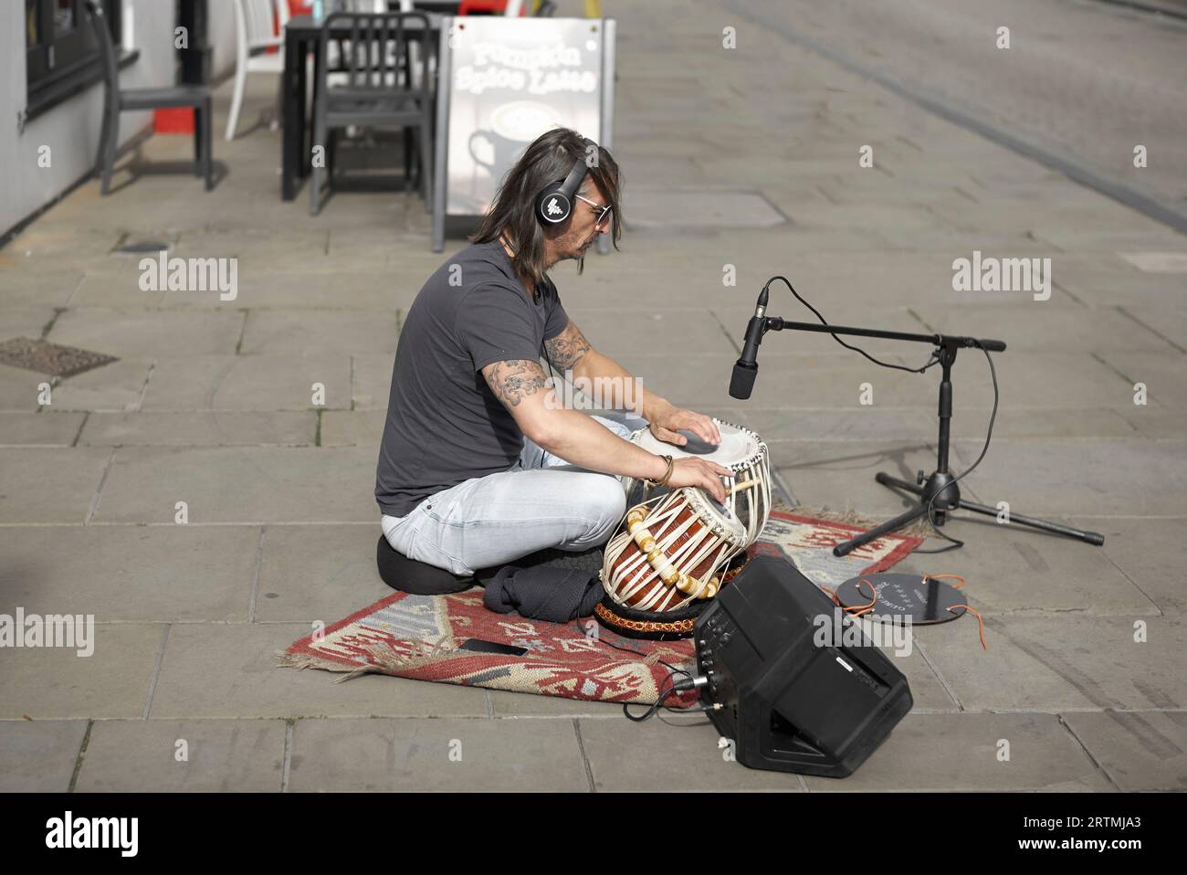 Busker playing the Bongo drums on the street at Stratford upon Avon ...