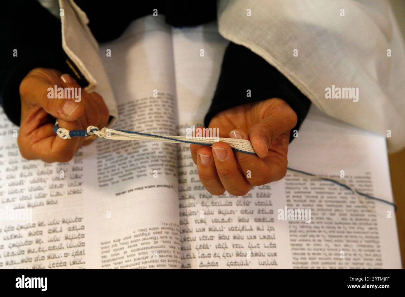 Jewish woman wearing a taleth and reading prayers in a Paris synagogue ...