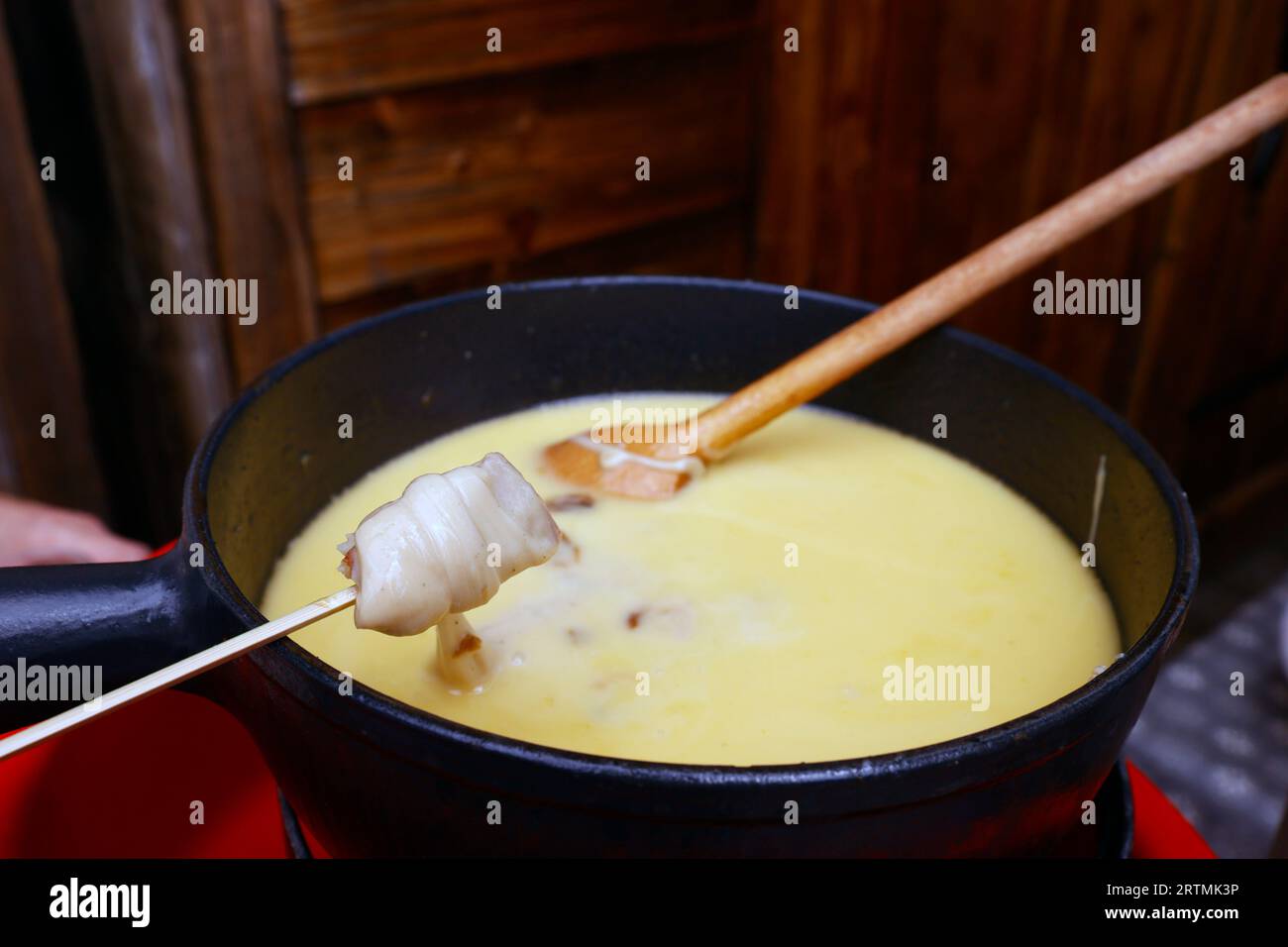 Traditional swiss cheese fondue at table in restaurant. Saint-Gervais ...