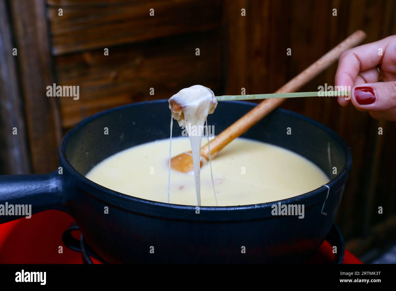 Traditional swiss cheese fondue at table in restaurant. Saint-Gervais ...