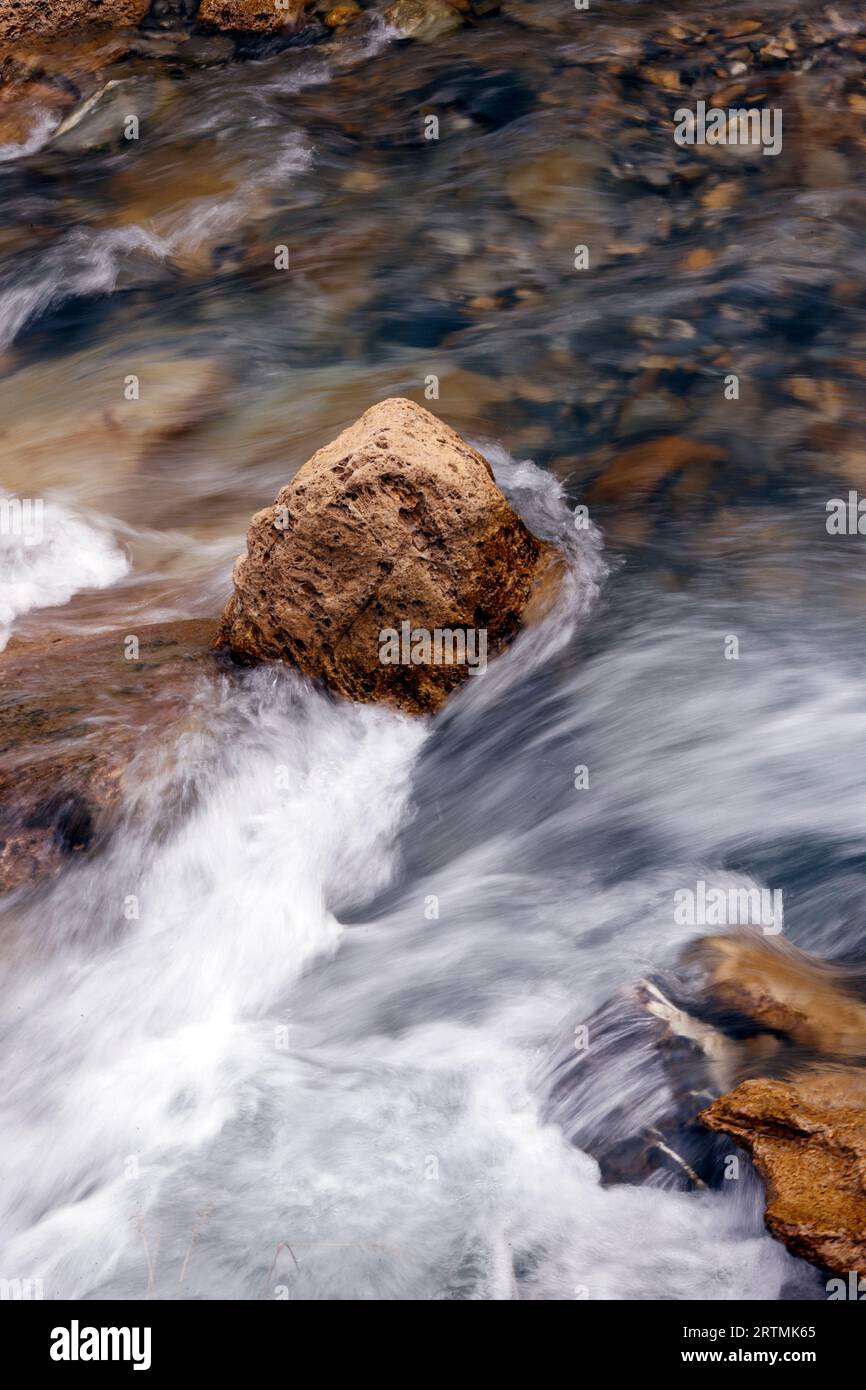 Mountain river flowing over rocks. River stony bottom. Cascade ...